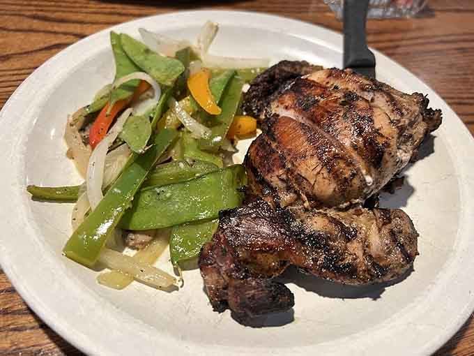 Jerk chicken with perfectly charred edges brings Caribbean heat to this Liverpool-loving establishment with delicious results.