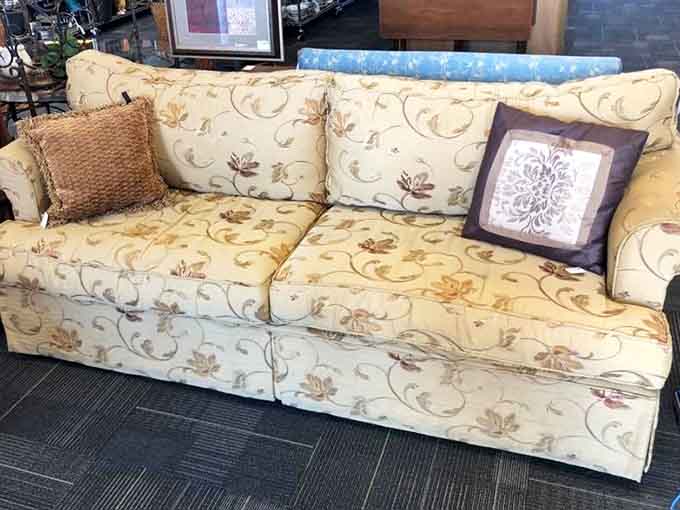 That floral couch is giving major Golden Girls vibes and could absolutely anchor your entire living room.