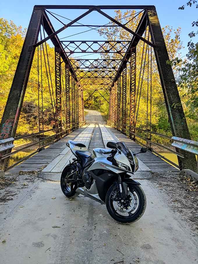Even motorcycles pause here, recognizing this crossing demands respect, not speed, like visiting your grandmother's house.