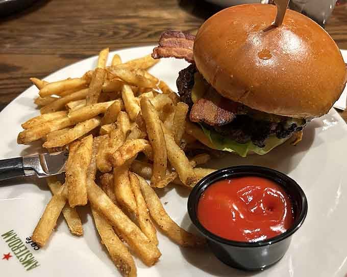 That burger sits tall and proud, stacked with bacon and all the fixings that make life worth living.