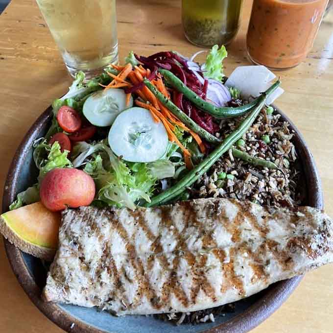 Grilled whitefish over wild rice with vegetables so colorful they could double as a Crayola advertisement from your childhood.