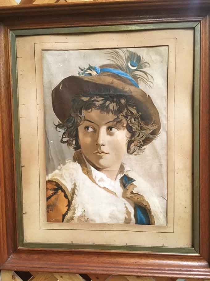 This vintage portrait captures an era when people dressed up just to have their picture taken, feather and all.