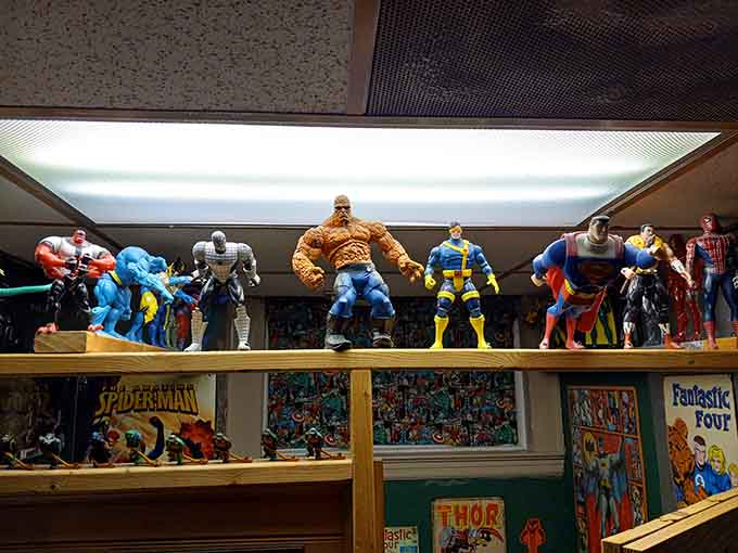 Marvel superheroes assembled on a shelf, watching over the gaming action like the world's nerdiest security team.