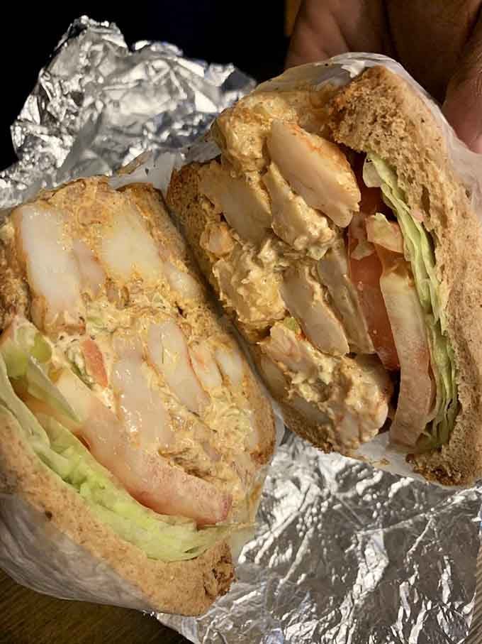 Shrimp salad that transforms a simple sandwich into an event requiring both hands and serious commitment to finish.