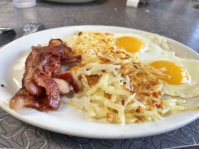 Sometimes simplicity is perfection: crispy bacon, perfectly cooked eggs, and golden hash browns done right every time.