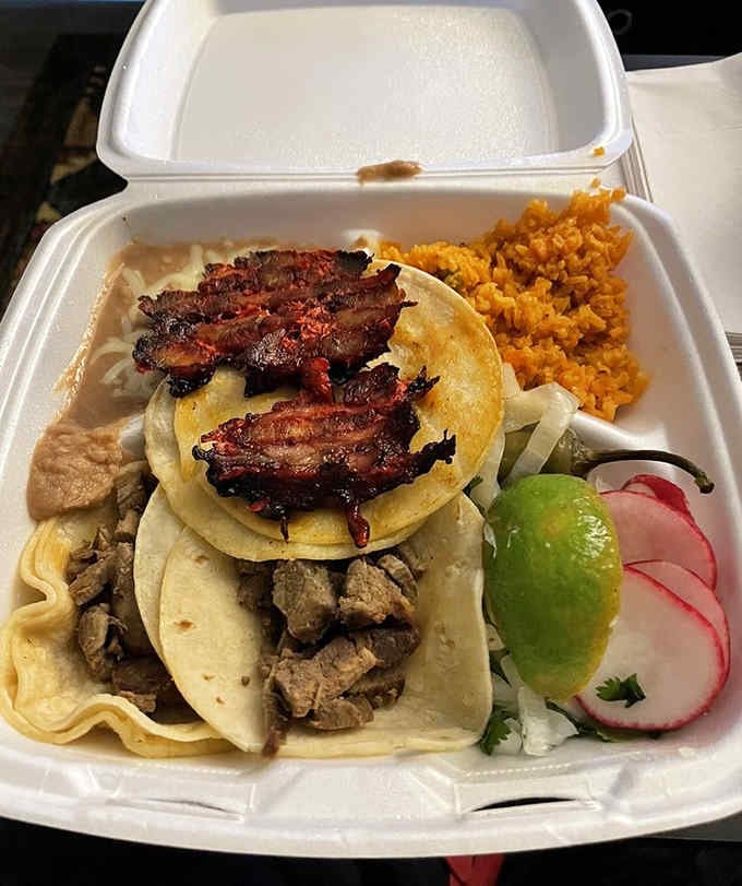 Two tacos showcasing the trompo and steak, each one a masterclass in how simple ingredients become something magical.