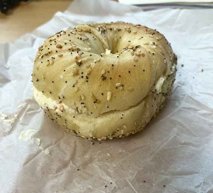 An everything bagel loaded with veggie cream cheese proves that simple combinations create the most memorable meals.