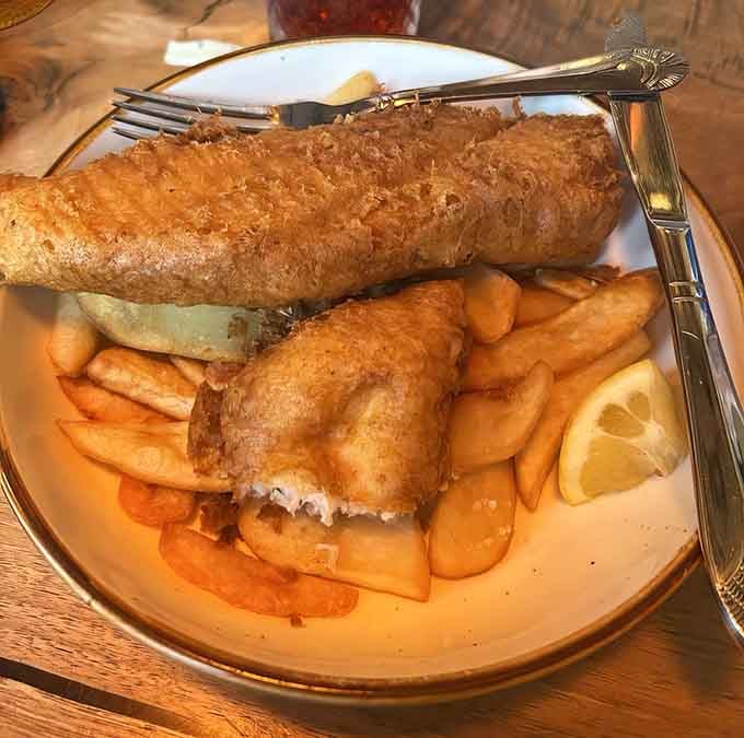 Golden, crispy fish and chips served with a lemon wedge proves some classics never need improving, just perfecting.