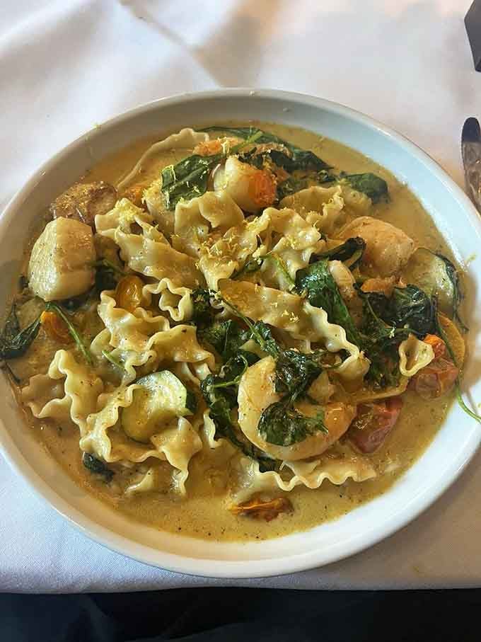 Shrimp and scallops swimming in creamy broth with noodles, comfort food fit for your inner monarch.