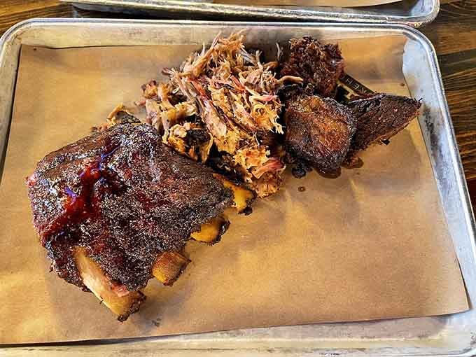 Three different cuts of perfectly smoked meat on one tray, like a greatest hits album you can actually eat.