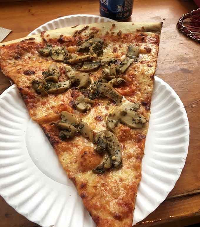 Mushroom and garlic on a slice that proves size really does matter when it comes to pizza.