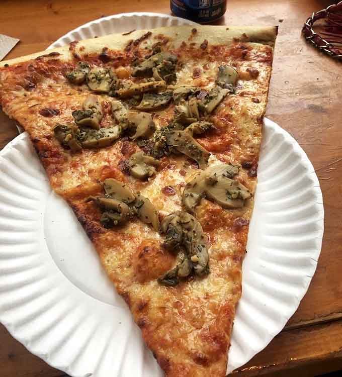 Mushrooms and garlic on a slice this size means you're getting actual vegetables with your cheese delivery system.