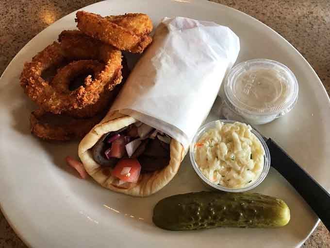 Crispy onion rings and a loaded gyro prove that lunch here means business, pickle spear and all included.