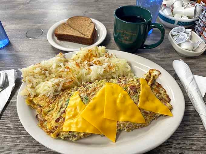 That omelet looks like it could feed a small army or one very determined breakfast enthusiast.