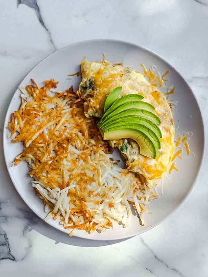 Golden hash browns meet fluffy eggs in this California Omelette that understands what breakfast should be.