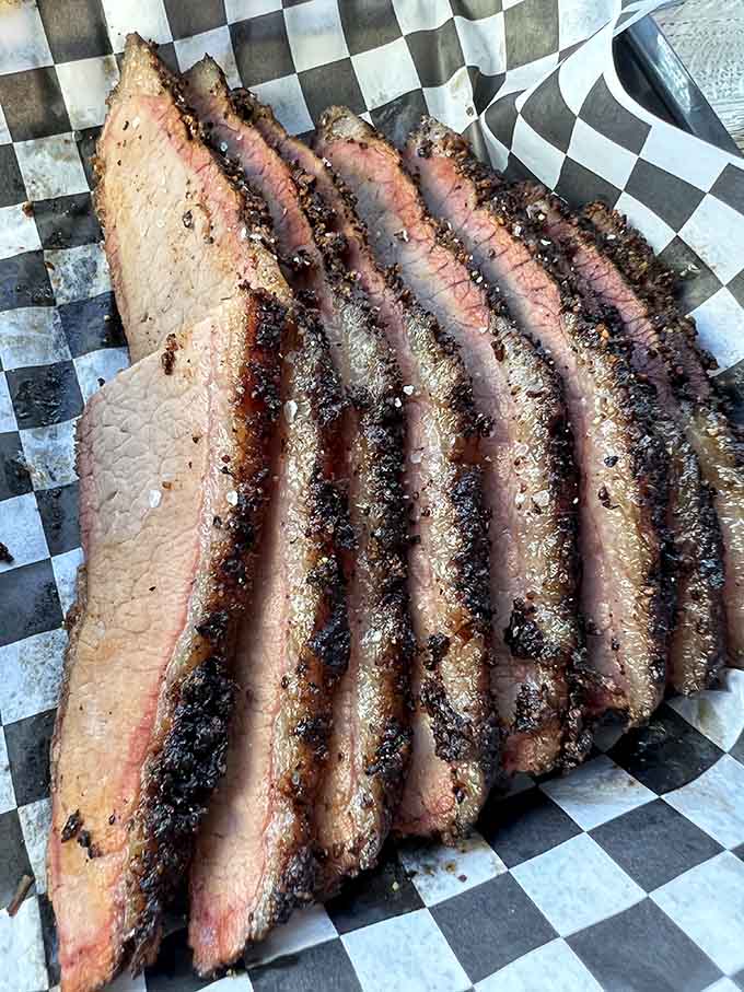 Sliced brisket with that coveted bark and pink smoke ring is what barbecue dreams are made of, literally.