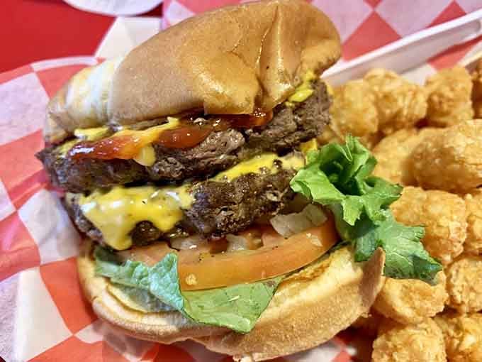 This double-stacked beauty with melted cheese and crispy tots proves that some engineering marvels don't require blueprints, just appetite.