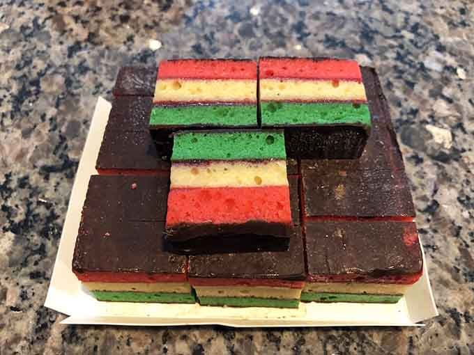Rainbow cookies stacked like tiny, tri-colored monuments to Italian-American baking genius, each layer a love letter wrapped in chocolate.