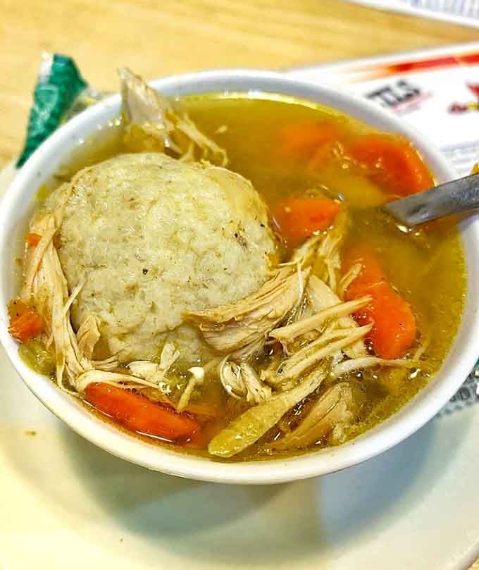 That matzo ball floats like a fluffy cloud in golden broth, ready to cure whatever ails you with every comforting spoonful taken.