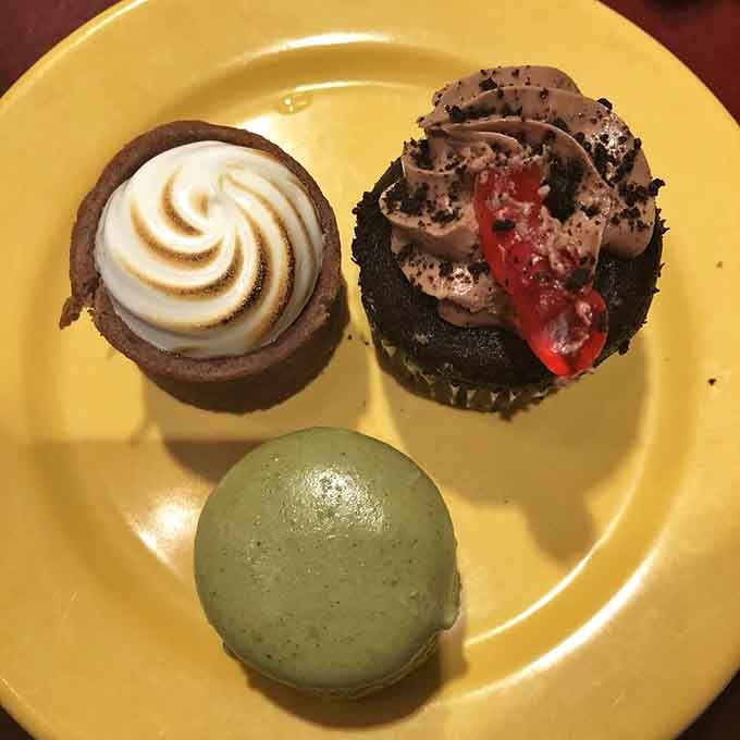 Three perfect bites of pure happiness: toasted meringue, chocolate indulgence, and a mint macaron for good measure.