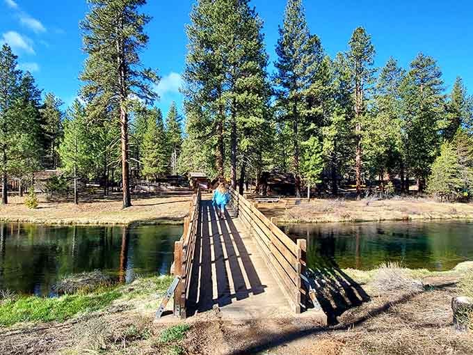 A simple wooden bridge crosses pristine waters, connecting past and present in Southern Oregon's hidden paradise.