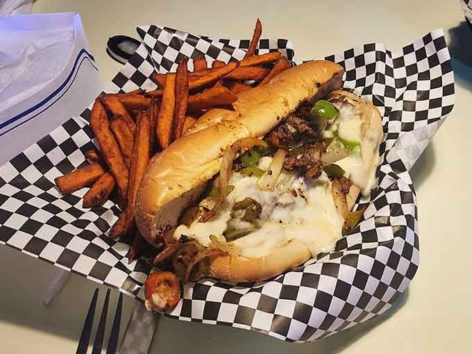 A cheesesteak that doesn't apologize for anything, served with sweet potato fries that add a touch of class to chaos.