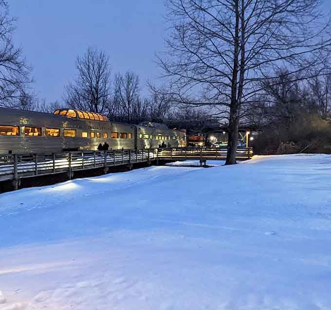 Winter transforms the platform into a snow-dusted scene where warm train lights promise cozy adventures through frozen landscapes.