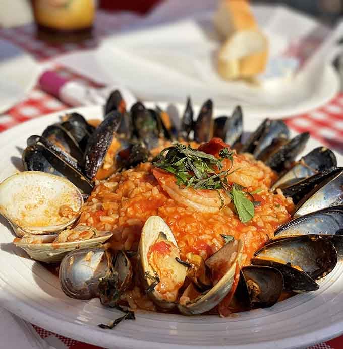 Risotto loaded with shellfish and shrimp that looks like the ocean decided to throw a party on rice.