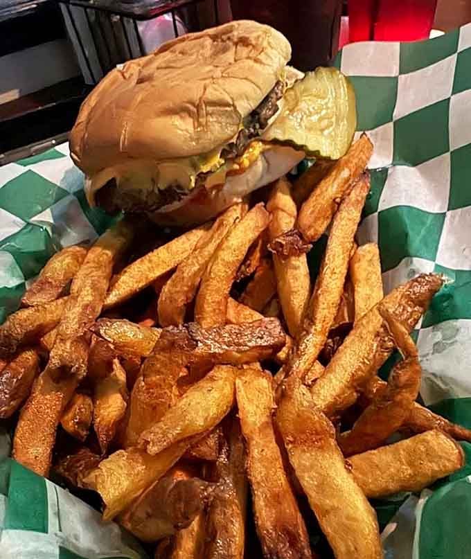 Golden fries piled high next to a juicy burger: this is what happiness looks like on a plate.