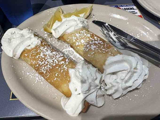 Swedish blintzes dusted with powdered sugar like edible snow, because sometimes breakfast needs a touch of elegance.
