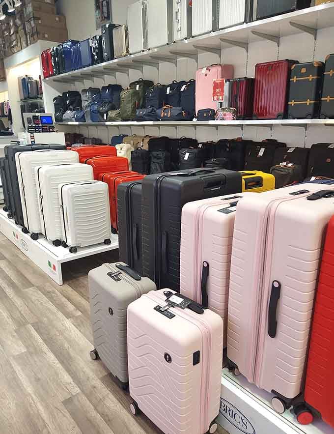 This rainbow of rolling luggage makes you want to book a trip just to justify buying one in every color.