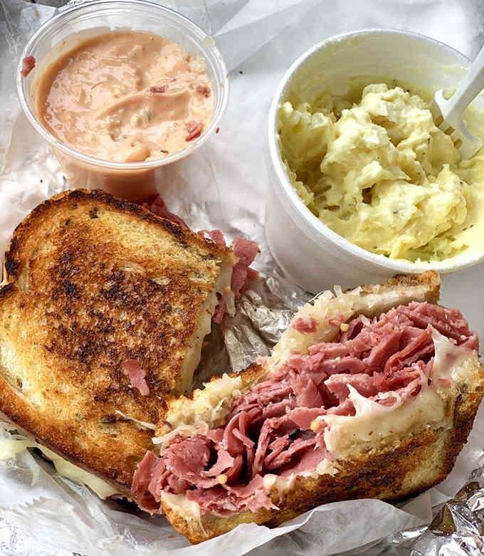 Corned beef piled high with sides that complete the picture of deli perfection done right.