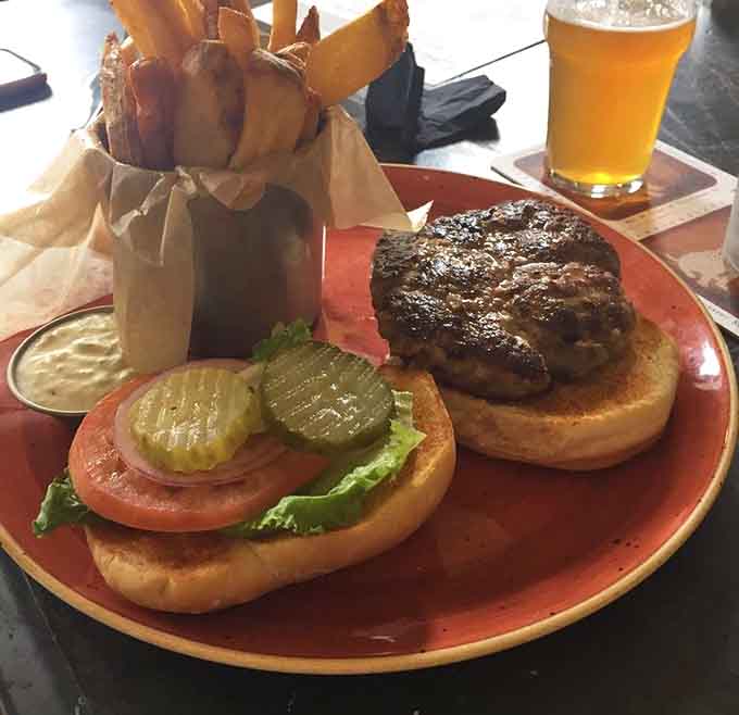 The lamb burger sits there looking proud of itself, and honestly, with those toppings and that perfectly cooked patty, it should be.