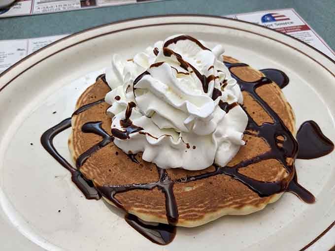 Oreo pancakes topped with whipped cream and chocolate drizzle turn breakfast into a celebration you didn't know you needed.