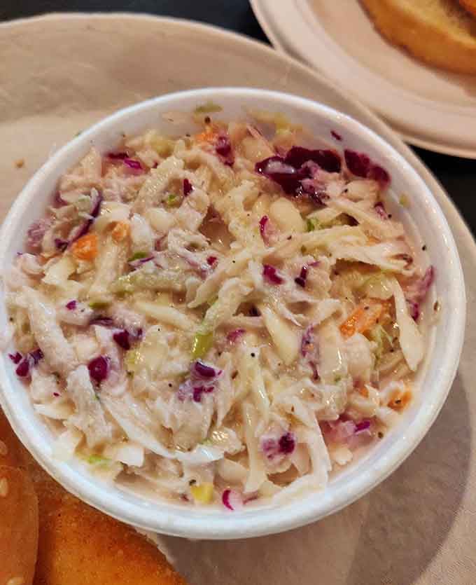This coleslaw brings the crunch and tang without drowning in mayo like some misguided swimming pool disaster.
