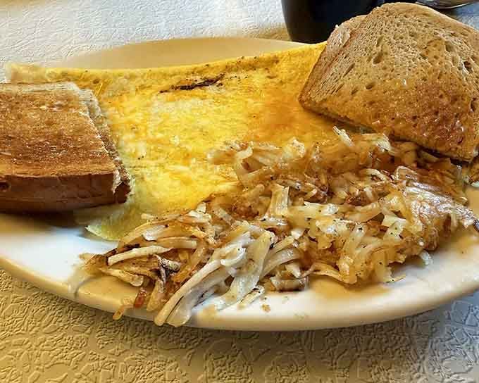 A perfectly cooked omelet with crispy hash browns and toast represents everything a classic diner breakfast should be and often isn't.