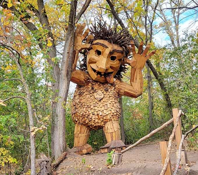 This whimsical wooden character guards the trails with more personality than most people you'll meet at the grocery store on Saturday.