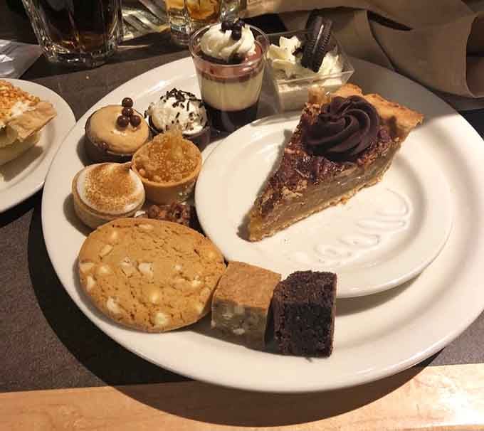 A dessert plate loaded with cookies, pie, and tiny treats represents the buffet philosophy in its purest form.