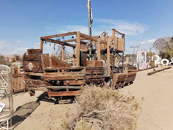 This wooden vessel looks ready to sail across sand dunes instead of ocean waves, defying all nautical logic.