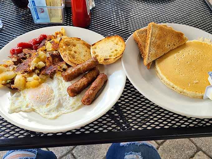 This breakfast spread features golden pancakes, crispy sausage, and eggs cooked exactly right, basically the breakfast trifecta of happiness.