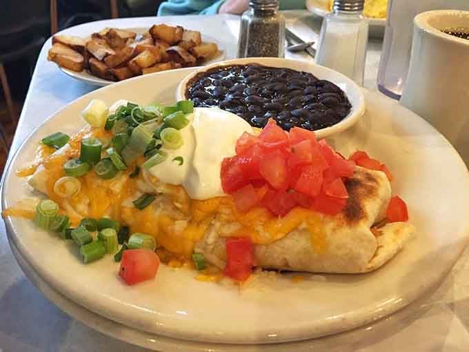 Loaded with cheese, scallions, tomatoes, and black beans, this breakfast burrito takes "starting your day right" to new heights.
