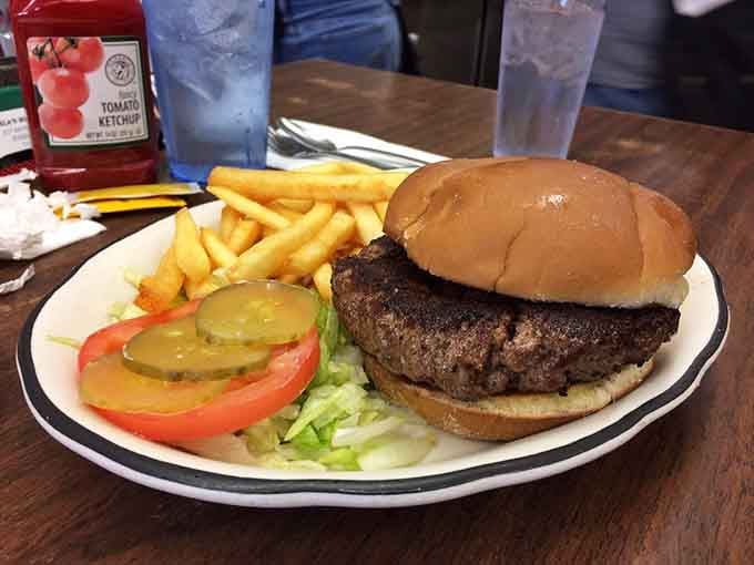 A perfectly grilled burger with golden fries shows that Estela's can nail American classics just as well as Mexican favorites.