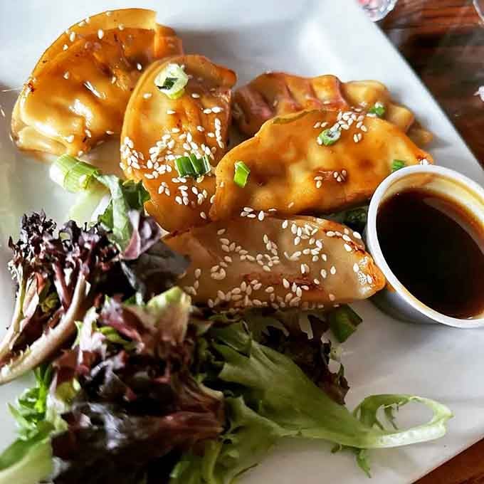 These dumplings arrive glistening with sesame seeds, ready to make you forget you came for pizza.