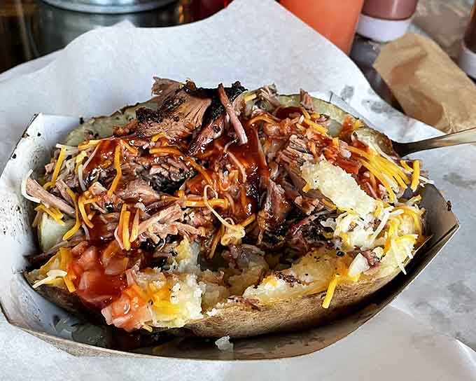 A loaded baked potato becomes dinner theater when it's piled high with smoky pulled pork and melted cheese.