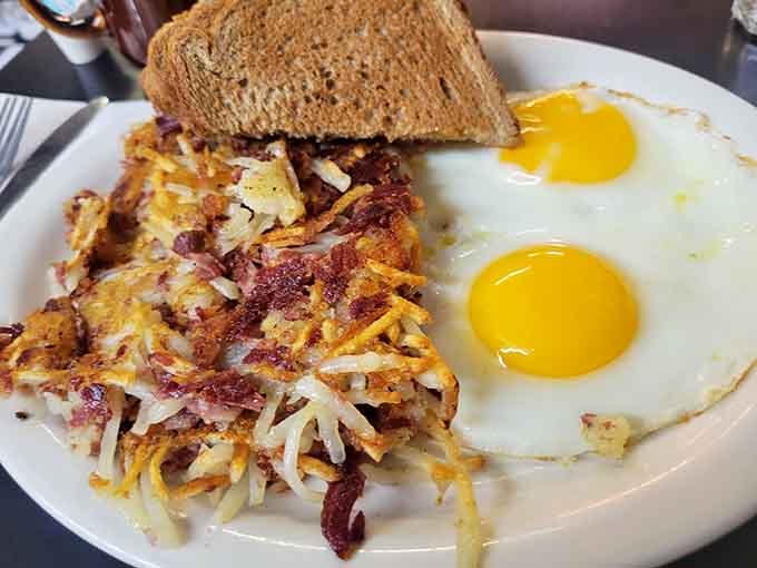 Hash browns achieving that perfect golden-brown crispy exterior while staying tender inside, the breakfast holy grail realized at last.