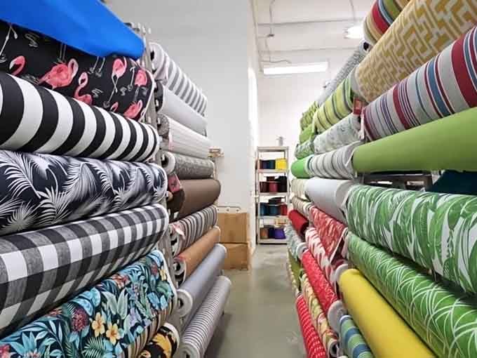 Aisles of fabric bolts stretching into the distance like a textile rainbow that goes on for days, not minutes.