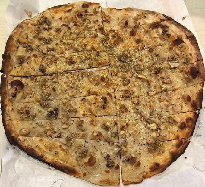 The legendary White Clam Pizza, looking exactly like the pie that launched a thousand pilgrimages to Wooster Street.