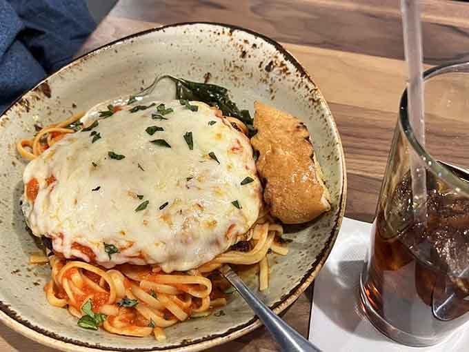 Chicken Parmesan over spaghetti delivers comfort in its purest form, topped with melted cheese that knows its job well.