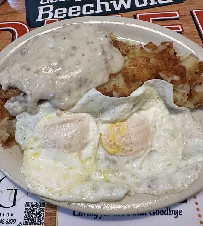 Country fried steak smothered in gravy alongside perfectly fried eggs, because some mornings demand Southern comfort.
