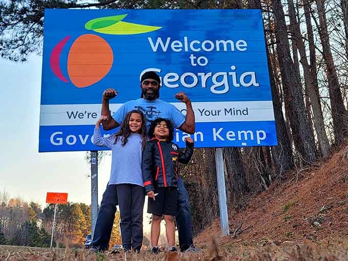 Pure joy captured in three smiling faces and one very photogenic sign that's seen countless family memories.